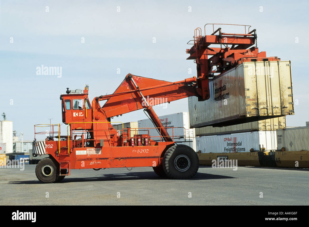 Moving shipping containers onto train car CP Rail yards Calgary Alberta ...