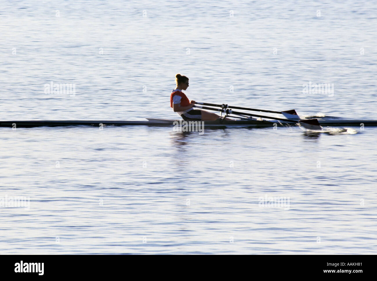 Solo female rower Stock Photo - Alamy