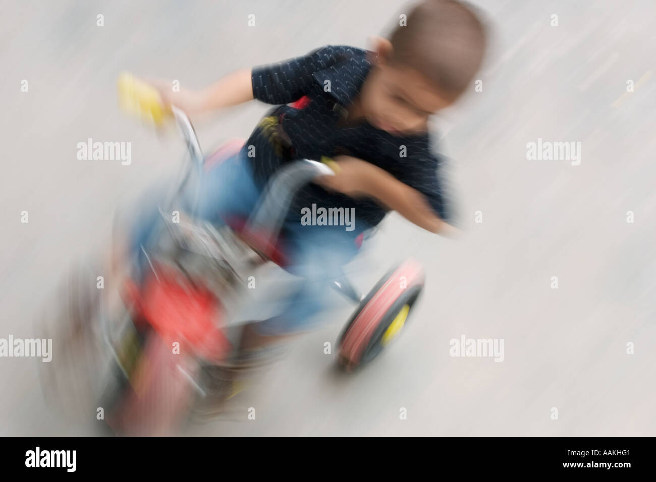 Child on tricycle hi-res stock photography and images - Alamy