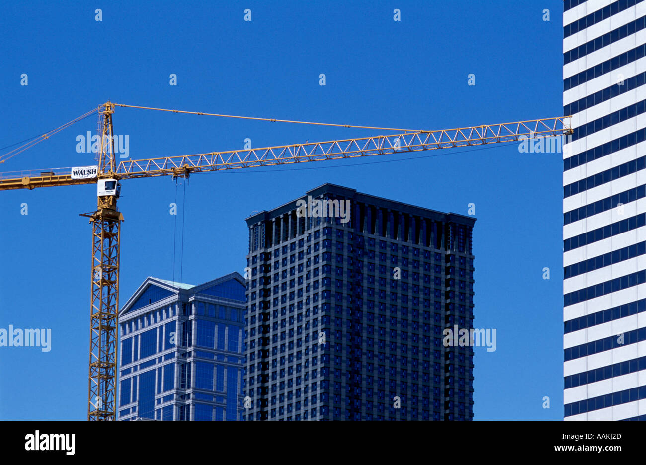 Tall Construction Crane at the Edge of Skyscrapers Stock Photo - Alamy