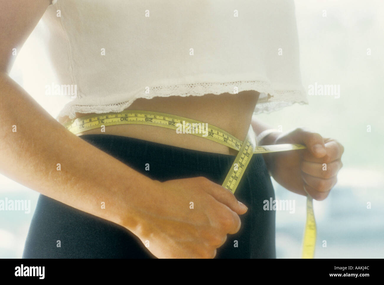 Woman measuring waist Stock Photo - Alamy