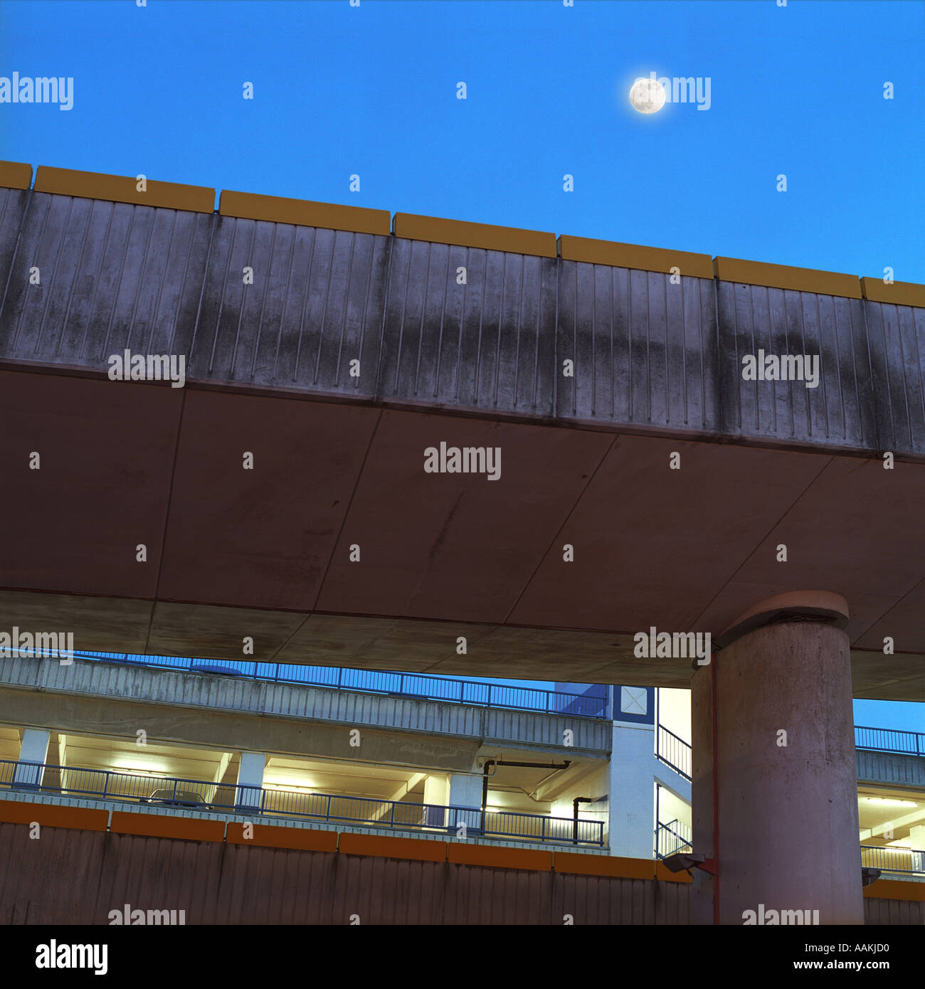 Night shot of car park exterior inc overhead ramp moon Stock Photo - Alamy