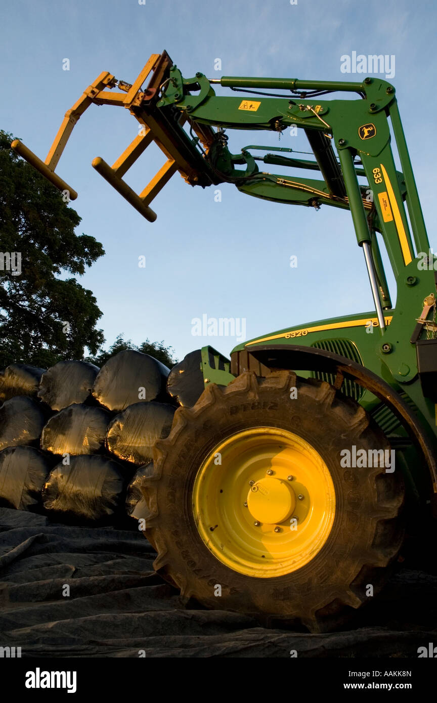 John Deere 6320 Loader tractor and wrapped silage bales, North ...