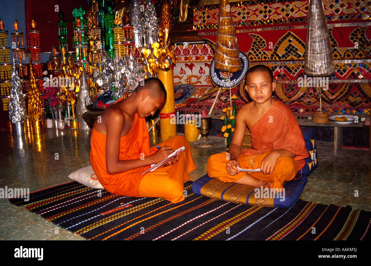 Buddhist monks sit in monestary in Laos, South East Asia Stock Photo ...