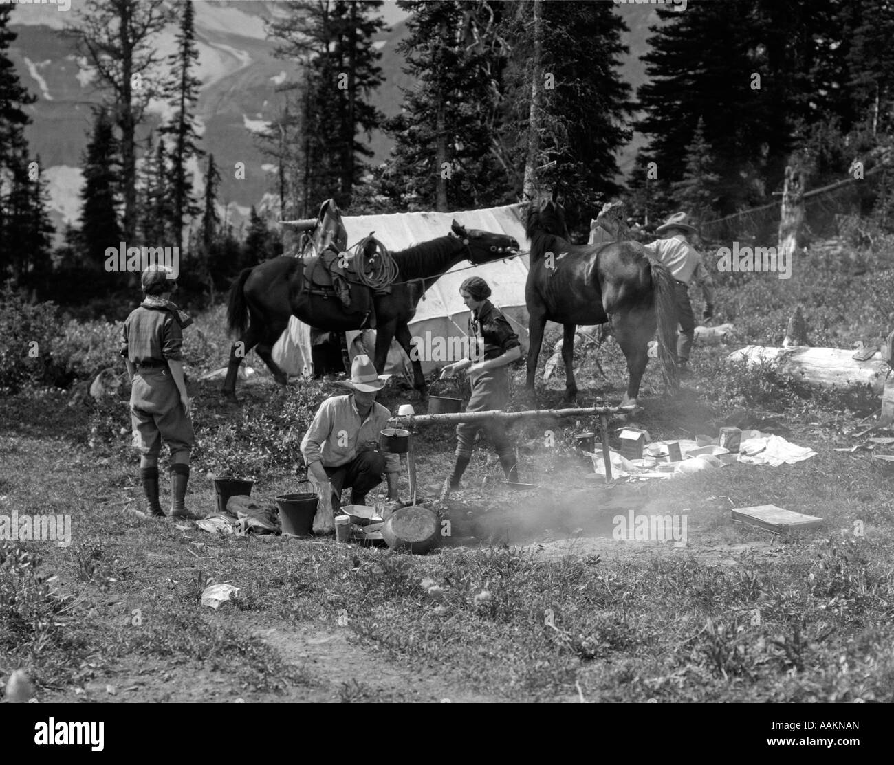 1920s GROUP MEN WOMEN AT ROUGH CAMPSITE COOKING FIRE HORSES CAMPFIRE ...
