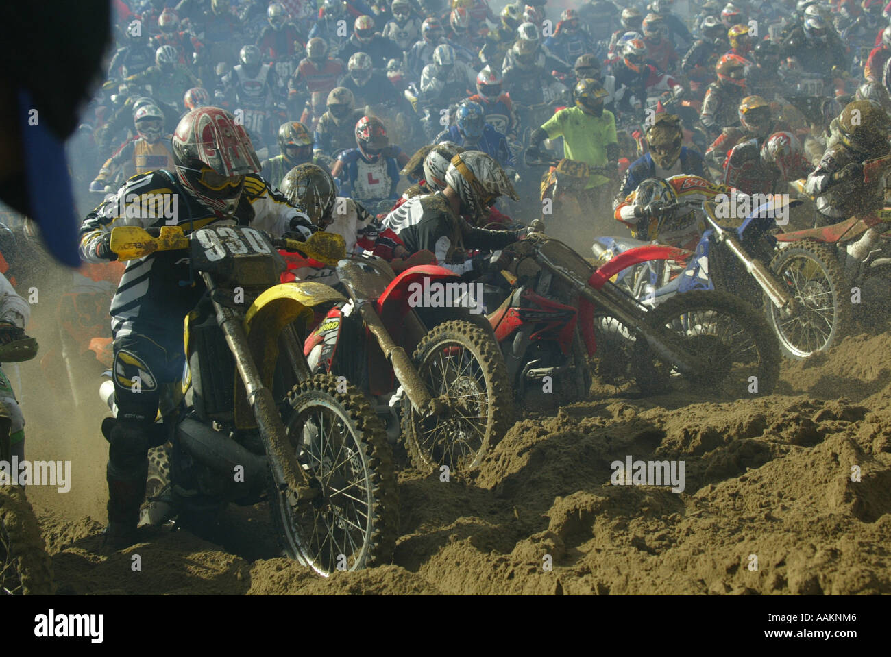 Hundreds of motorbikes climb a sand dune during a mass beach race in ...