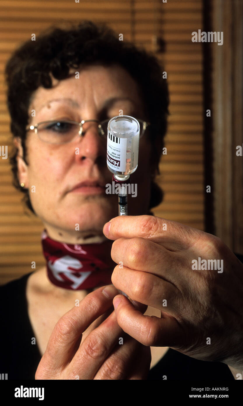 Diabetic woman drawing up an insulin injection, Suffolk, UK Stock Photo ...