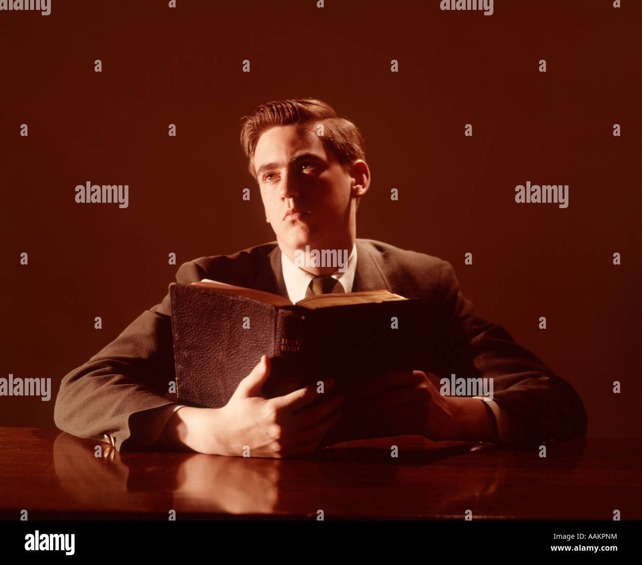 1960s YOUNG MAN LOOKING UPWARD HOLDING HOLY BIBLE Stock Photo - Alamy