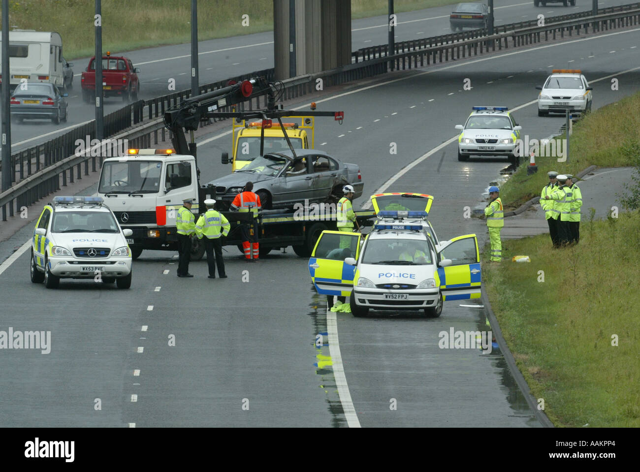 A BMW car is removed by Police following an accident on the motorway ...