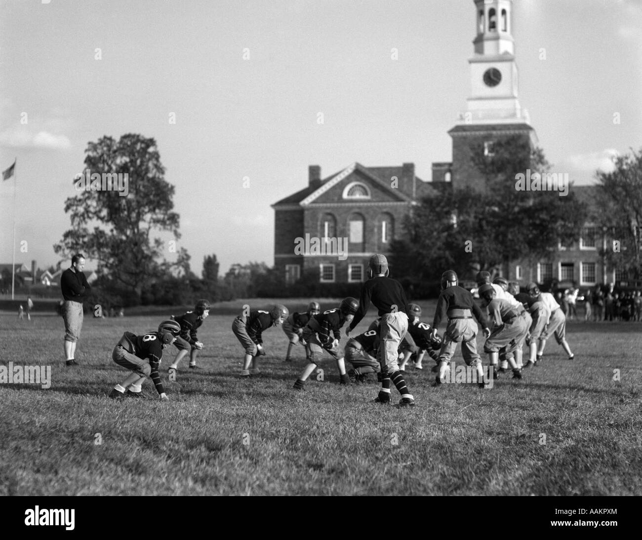 1930s BOYS SCHOOL FOOTBALL GAME PRACTICE COACH WATCHING Stock Photo - Alamy