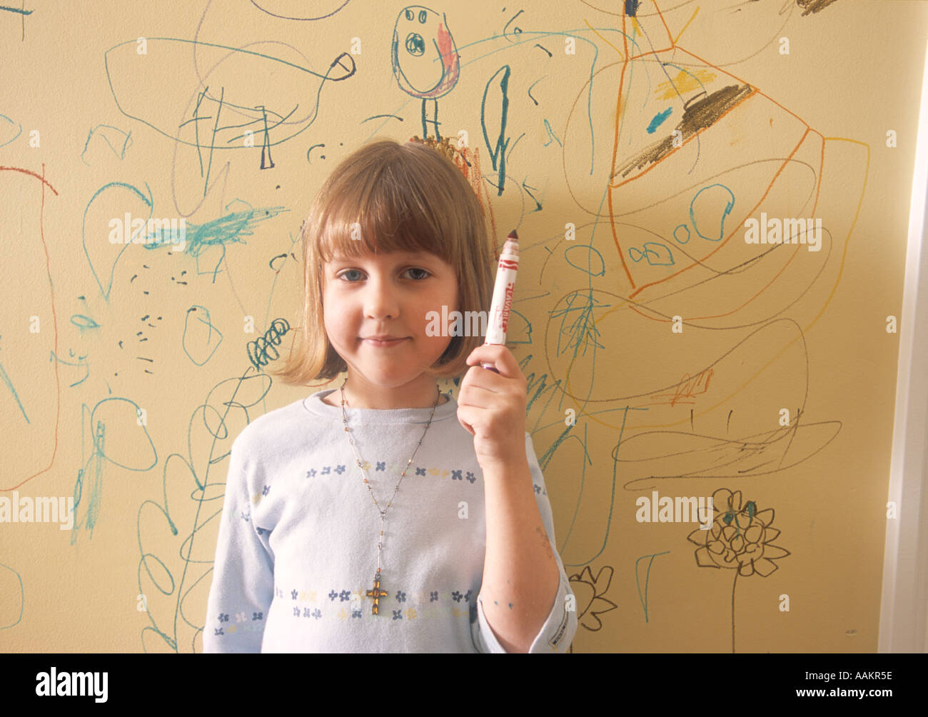 little girl writing on the wall of her house Stock Photo - Alamy