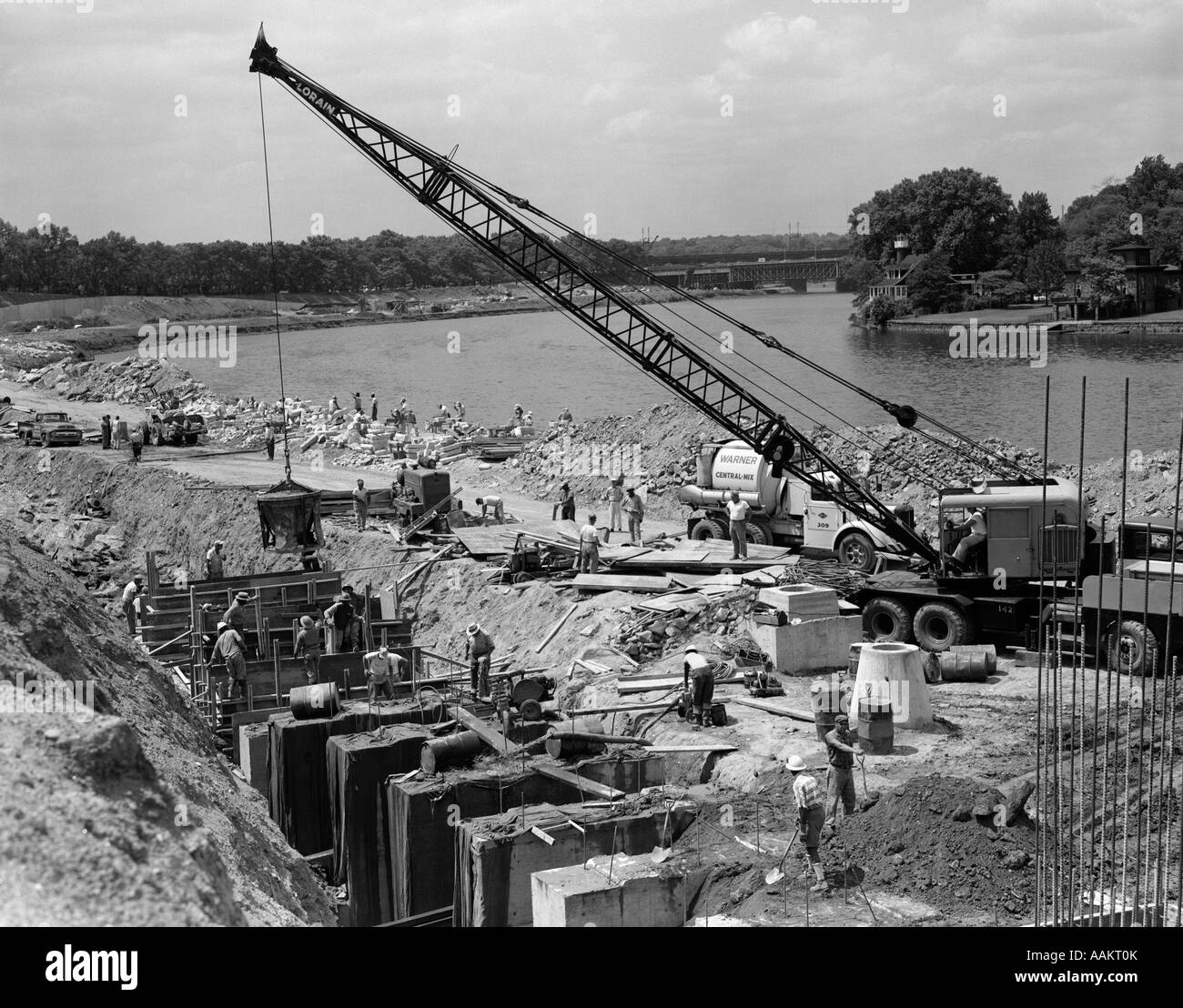 1950s 1960s HIGHWAY BRIDGE CONSTRUCTION BY SIDE OF RIVER WORKERS MEN ...