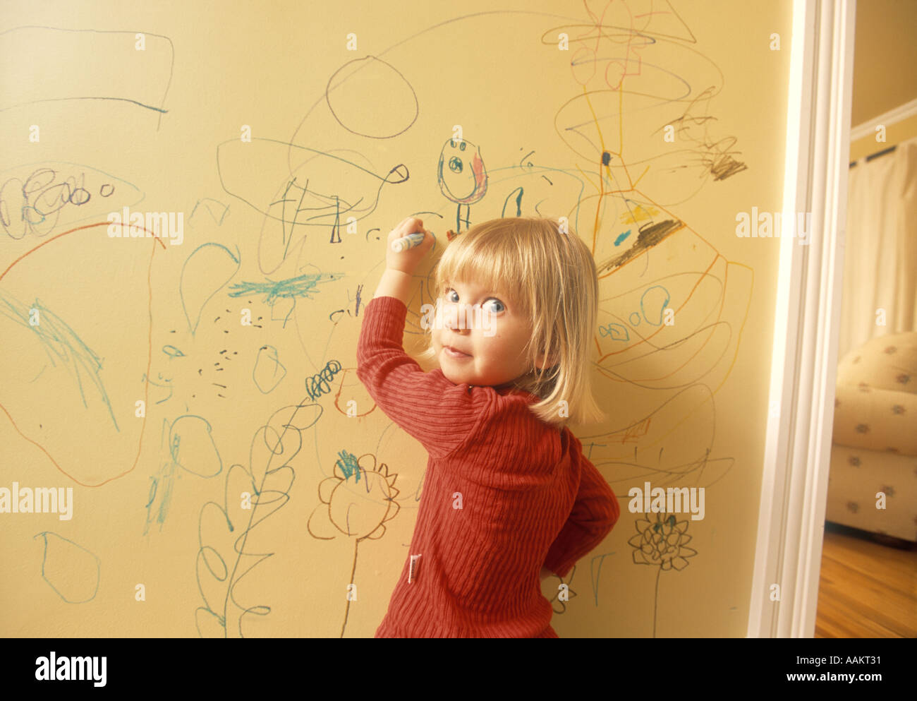 little girl writing on the wall of her house Stock Photo - Alamy