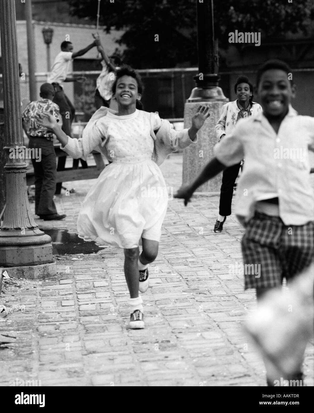1970s GROUP OF AFRICAN AMERICAN CHILDREN RUNNING DOWN SIDEWALK Stock ...