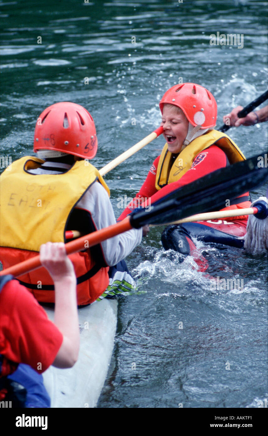 Cub Scouts aged 10 to 12 years play mop jousting in canoes on River ...