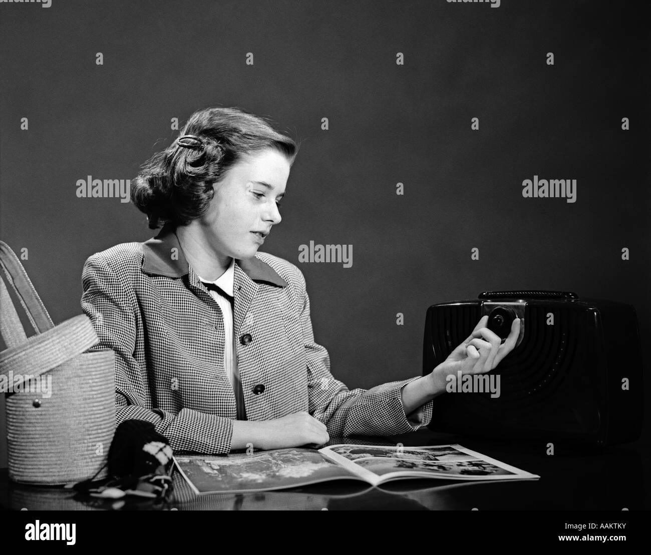1950s YOUNG TEEN GIRL TURNING DIAL ON RADIO READING MAGAZINE Stock ...