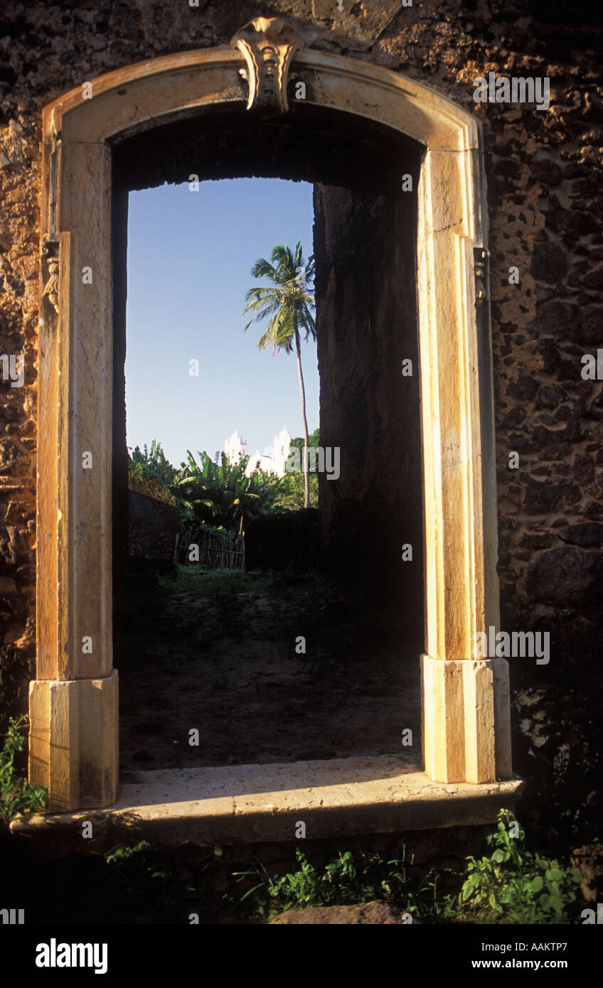 Church and palm tree seen through the window of colonial house' ruin ...