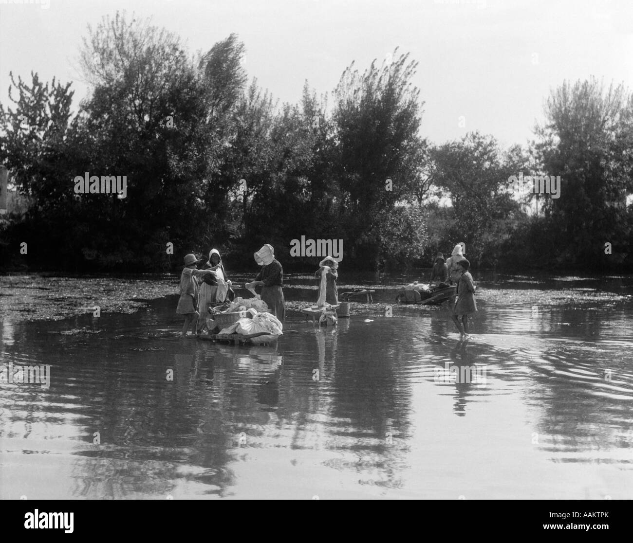 1920s GROUP OF WOMEN IN COSTUME OF RURAL FRANCE DOING LAUNDRY IN A ...