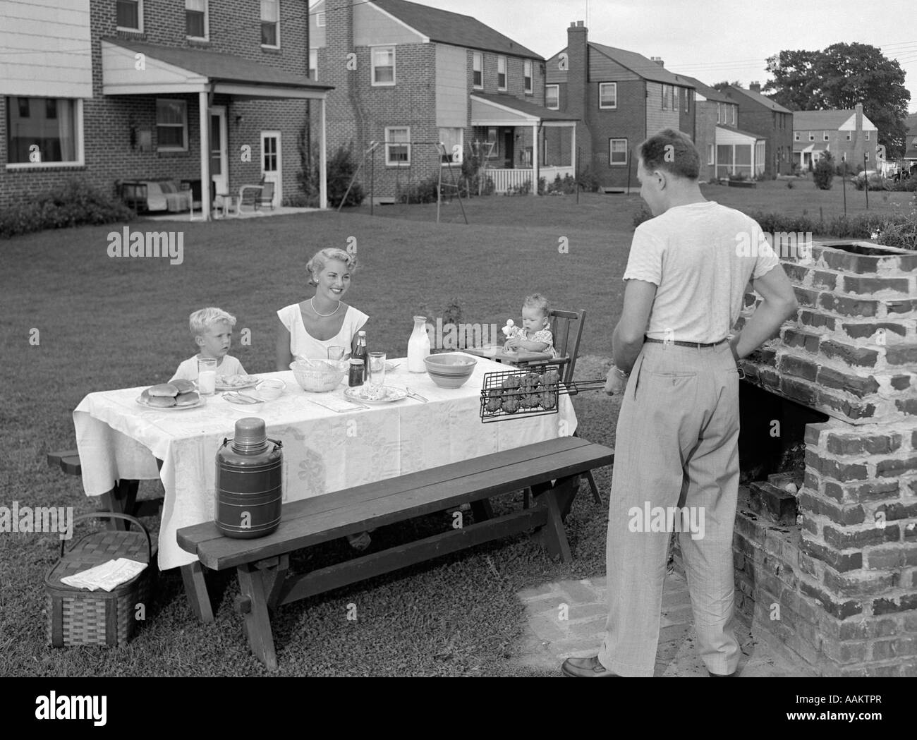 1940s 1950s FAMILY IN BACKYARD COOKING HAMBURGERS Stock Photo - Alamy
