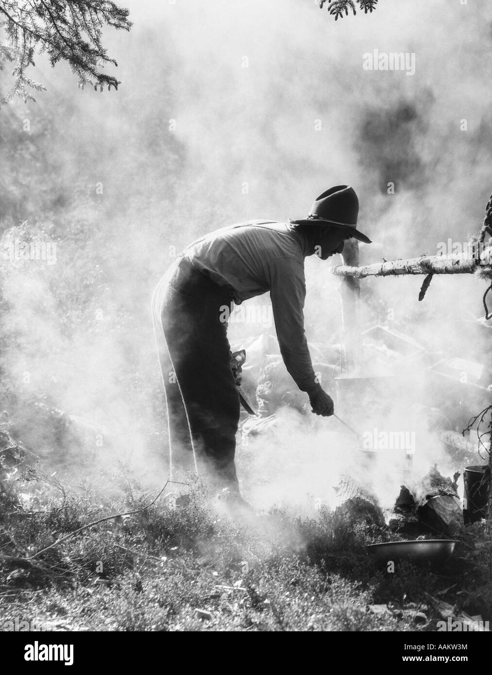 Person Tending Camp Fire