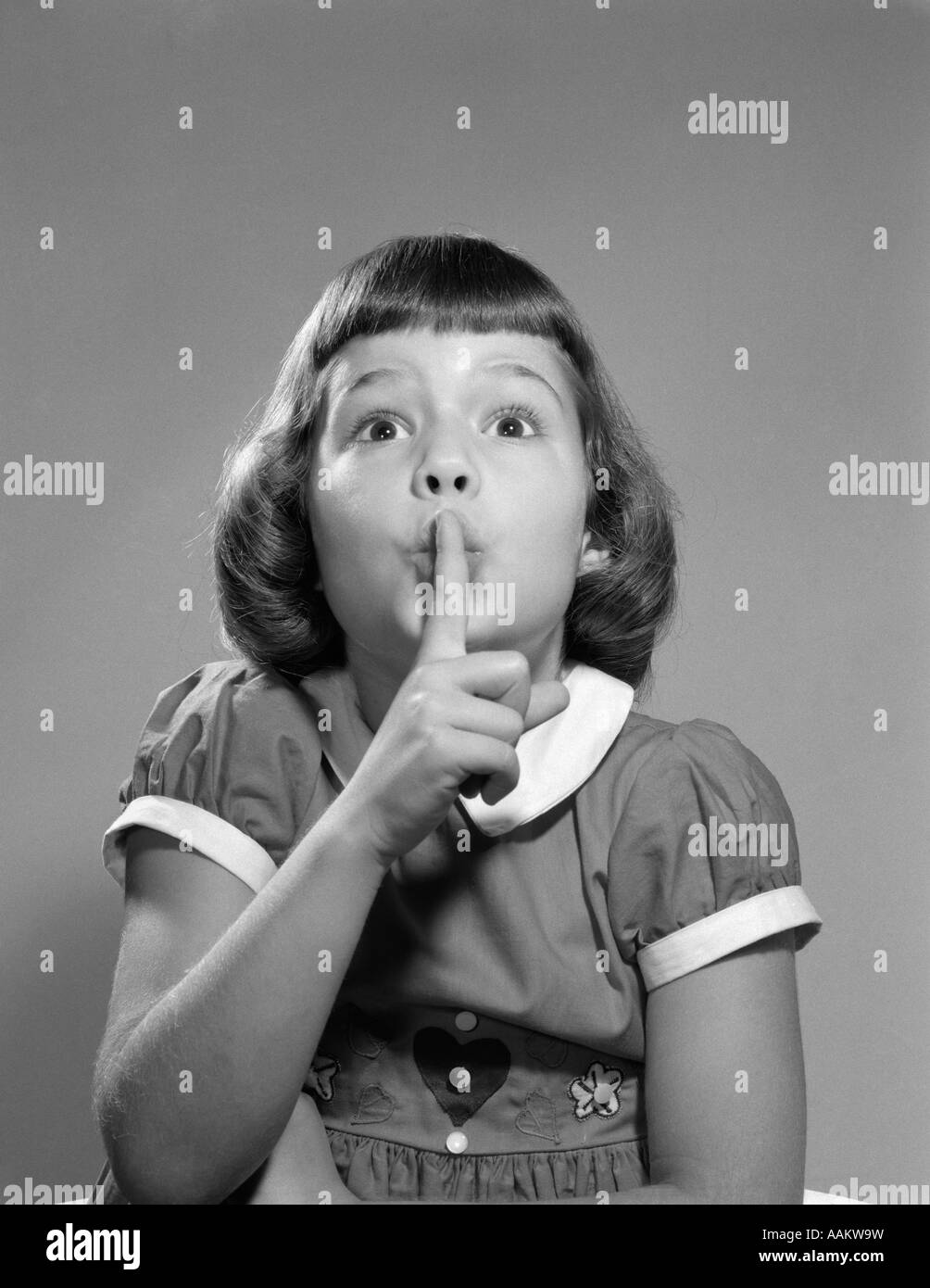 1950s GIRL MAKING QUIET SILENCE SHUSH GESTURE FINGER TO LIPS Stock ...