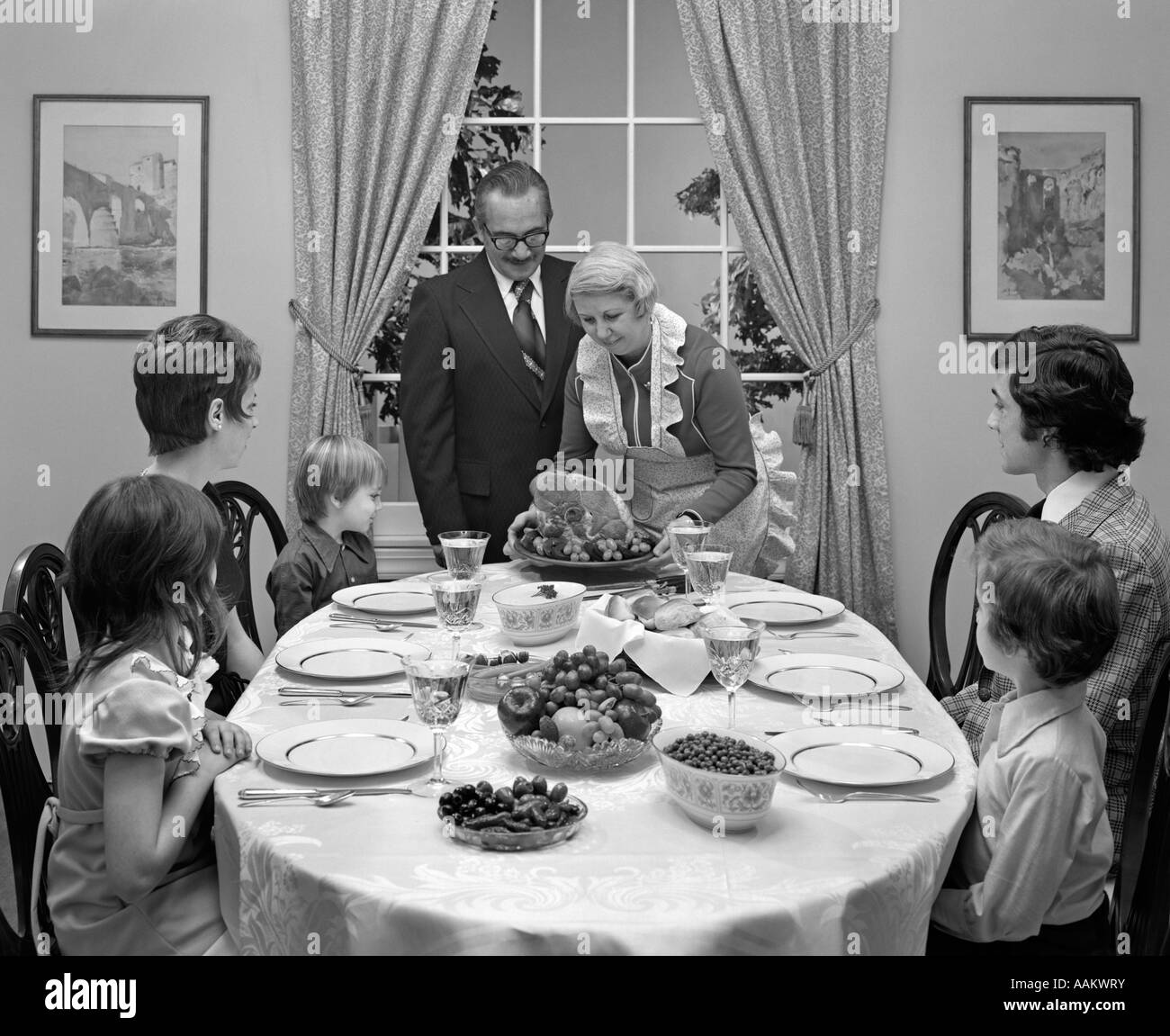 Family sitting table children Black and White Stock Photos & Images - Alamy