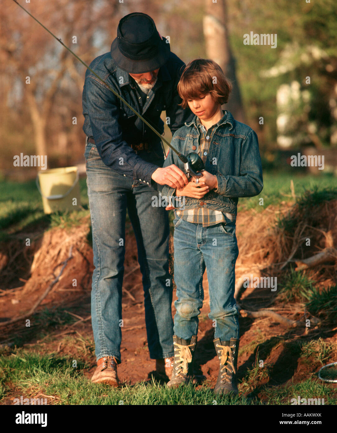 1970s BOTH WEARING DENIM CLOTHING MAN FATHER TEACHING BOY SON HOW TO ...