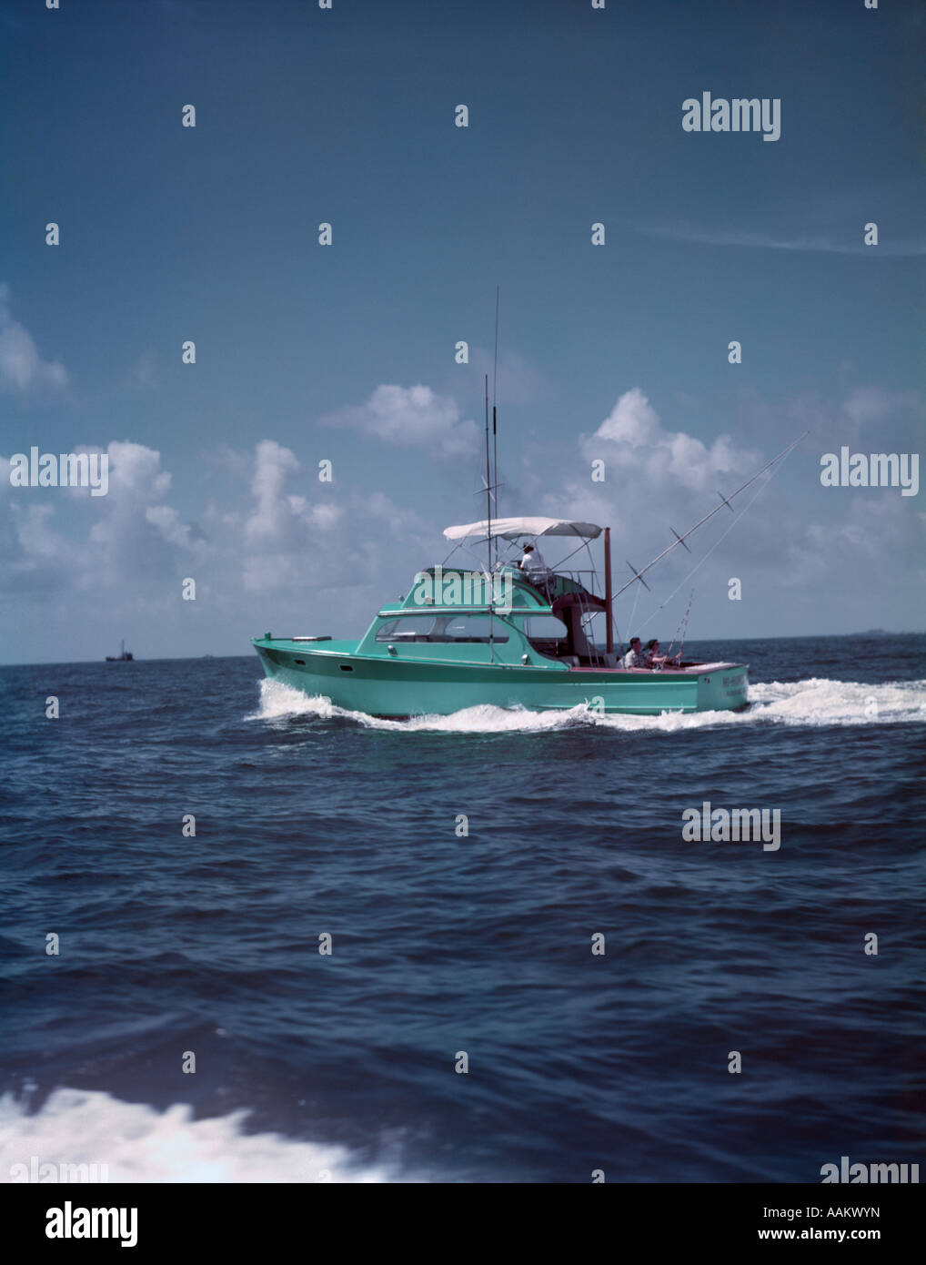 1950s CHARTER FISHING BOAT TURQUOISE BREAKING WHITE WAVE WAKE IN DEEP ...