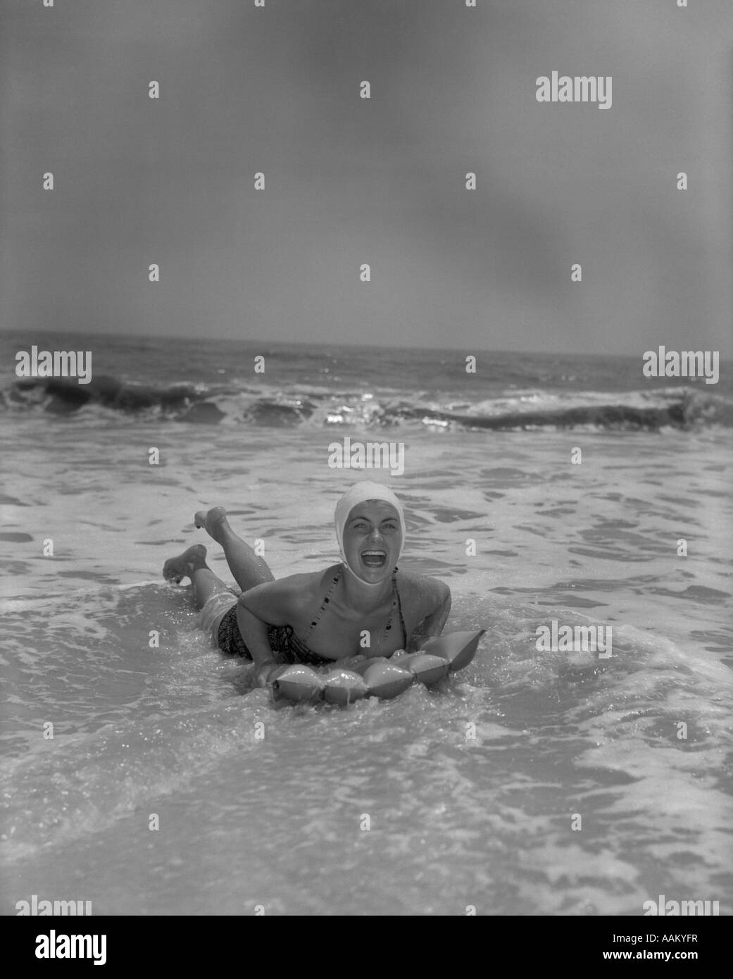 1950s LAUGHING WOMAN ON INFLATED RAFT IN SURF Stock Photo - Alamy