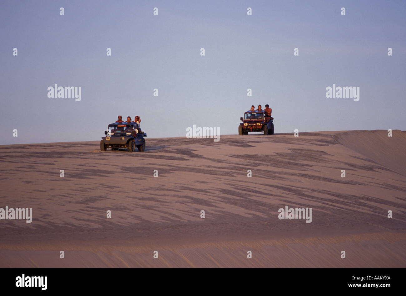 Travel and fun Tourists at buggy cars bugre in the dunes of ...