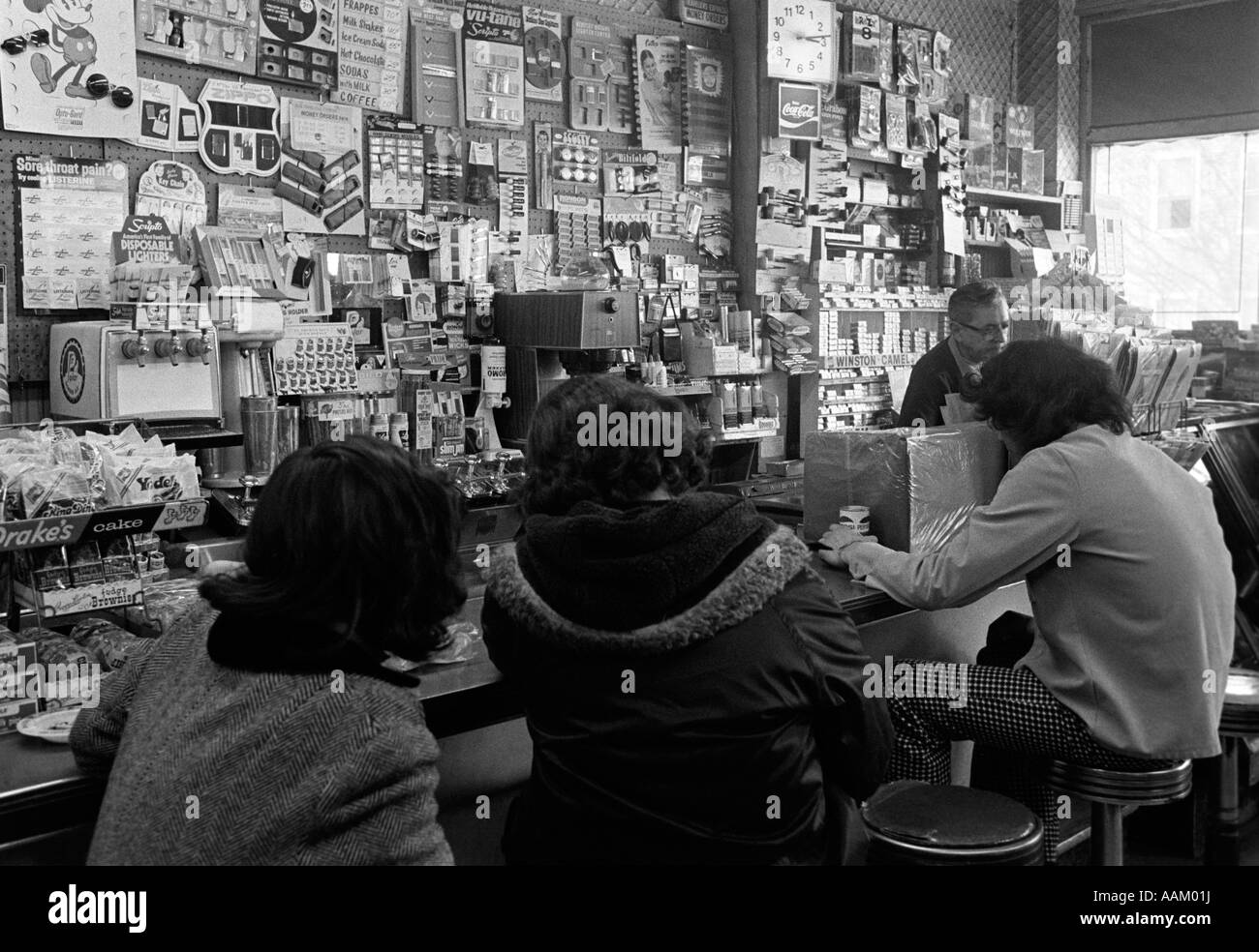 Boy sitting on counter Black and White Stock Photos & Images - Alamy