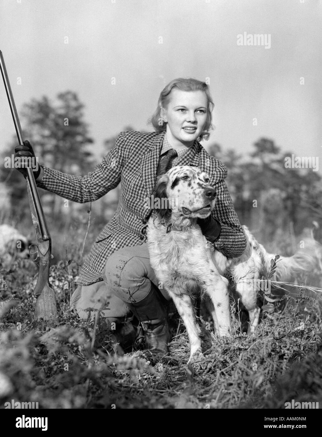 1940s Woman Hunter Wearing Tweed Suit Holding Shotgun In One Hand