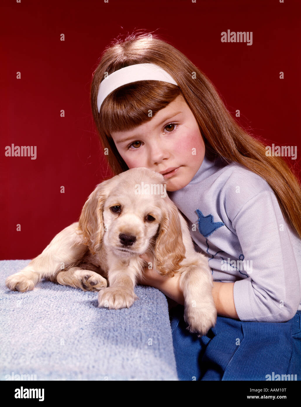 1970s PORTRAIT SERIOUS LITTLE GIRL HUGGING HER COCKER SPANIEL PUPPY DOG ...