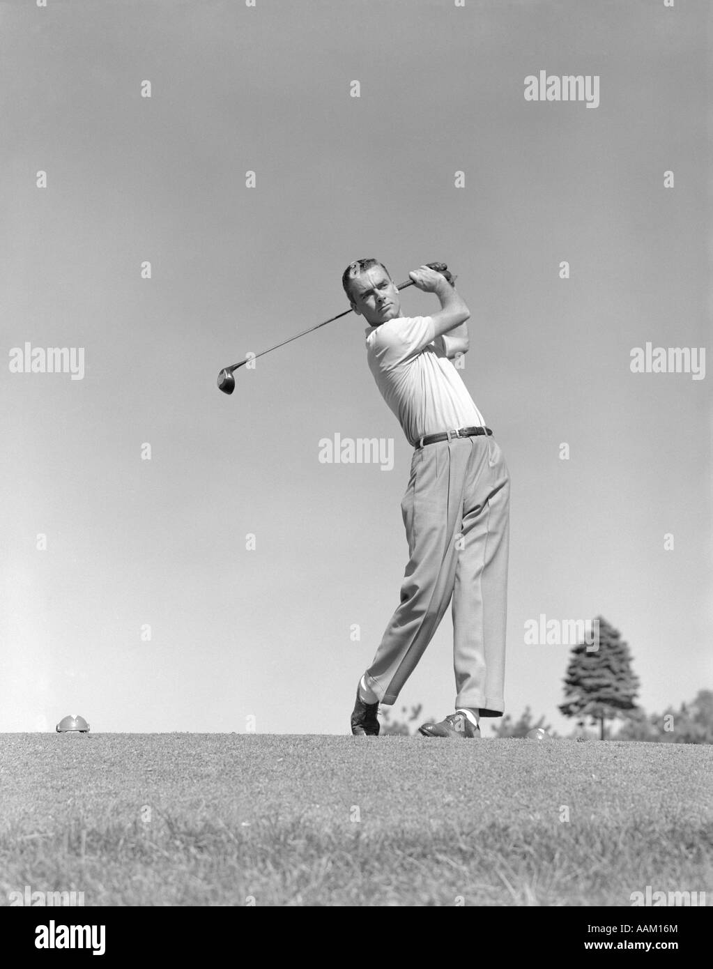 1950s MAN GOLFER CLUB RAISED ABOUT TO TAKE FULL SWING STANCE POSITION ...