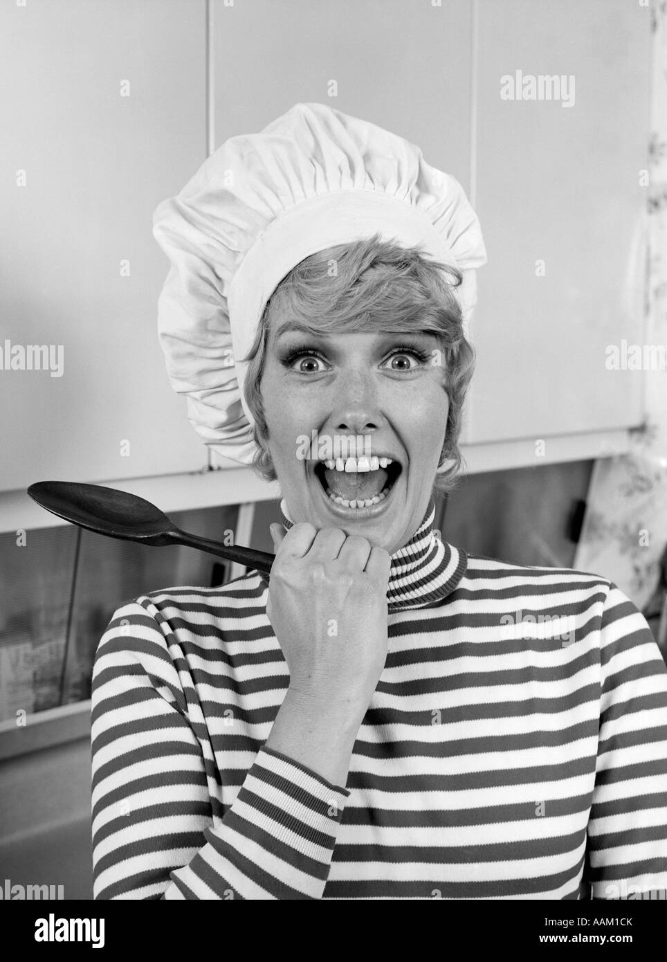 1970s WOMAN PORTRAIT WEARING CHEF'S TOQUE IN KITCHEN WITH SURPRISED ...