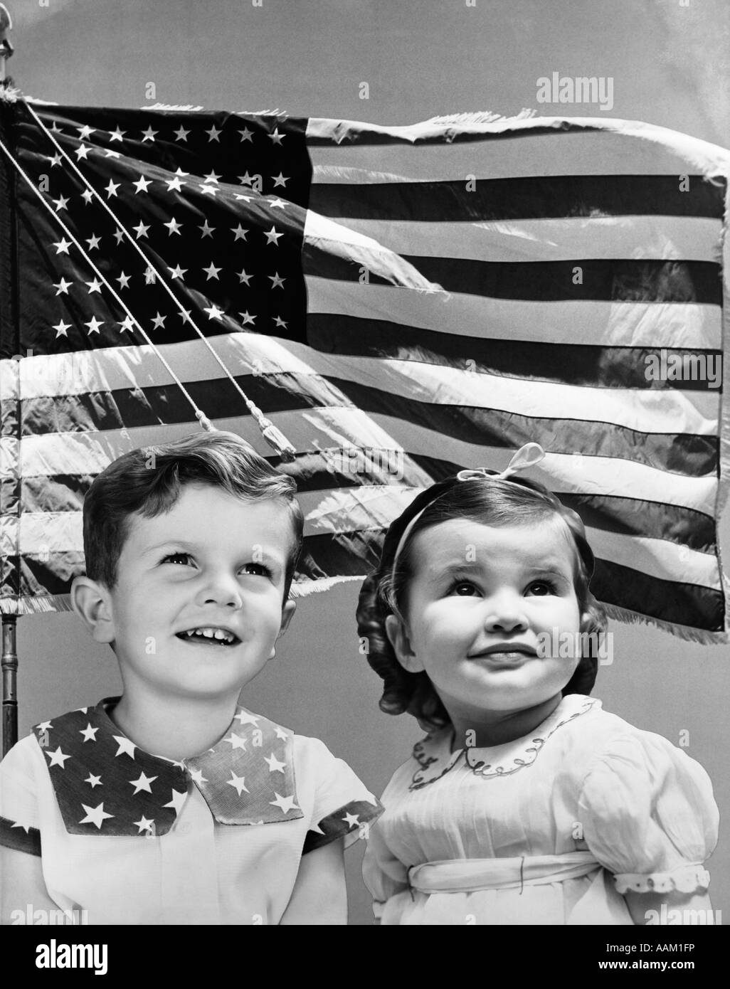 1940s PATRIOTIC COMPOSITE OF SMILING BOY AND GIRL OVER BACKGROUND OF ...