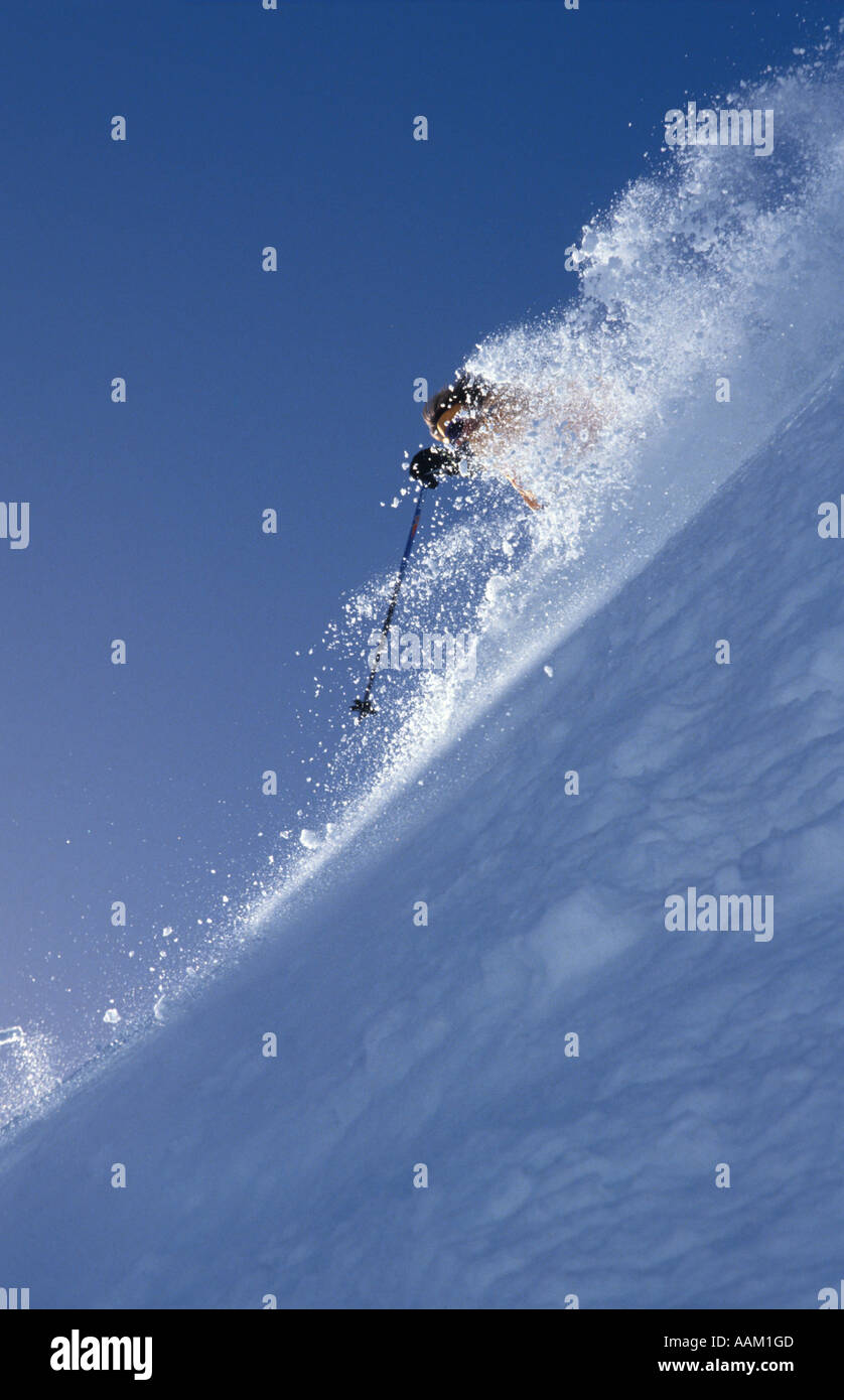 woman skier going down a steep slope in a cloud of snow Stock Photo - Alamy