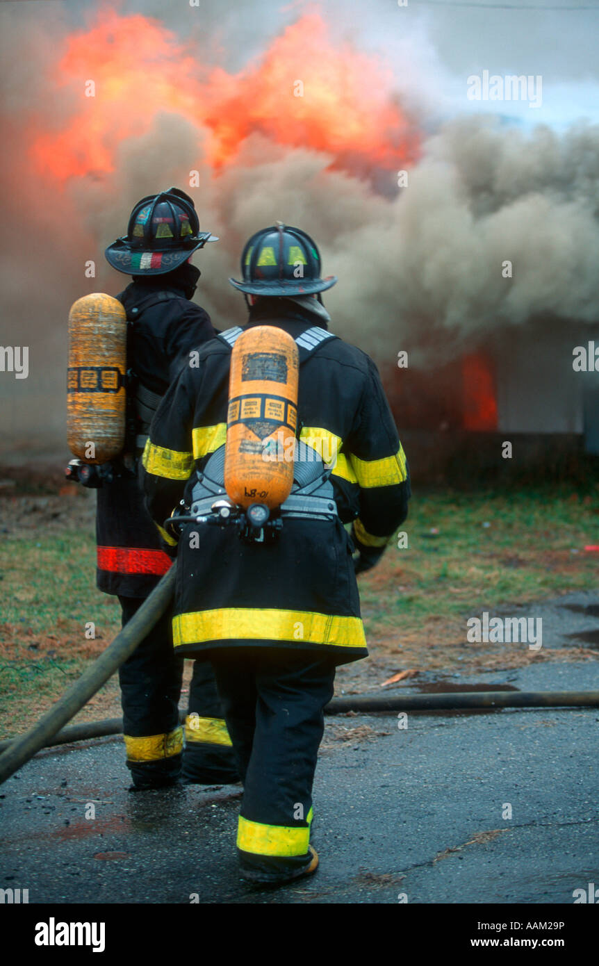 FIREMEN SPRAYING WATER ON FIRE Stock Photo - Alamy