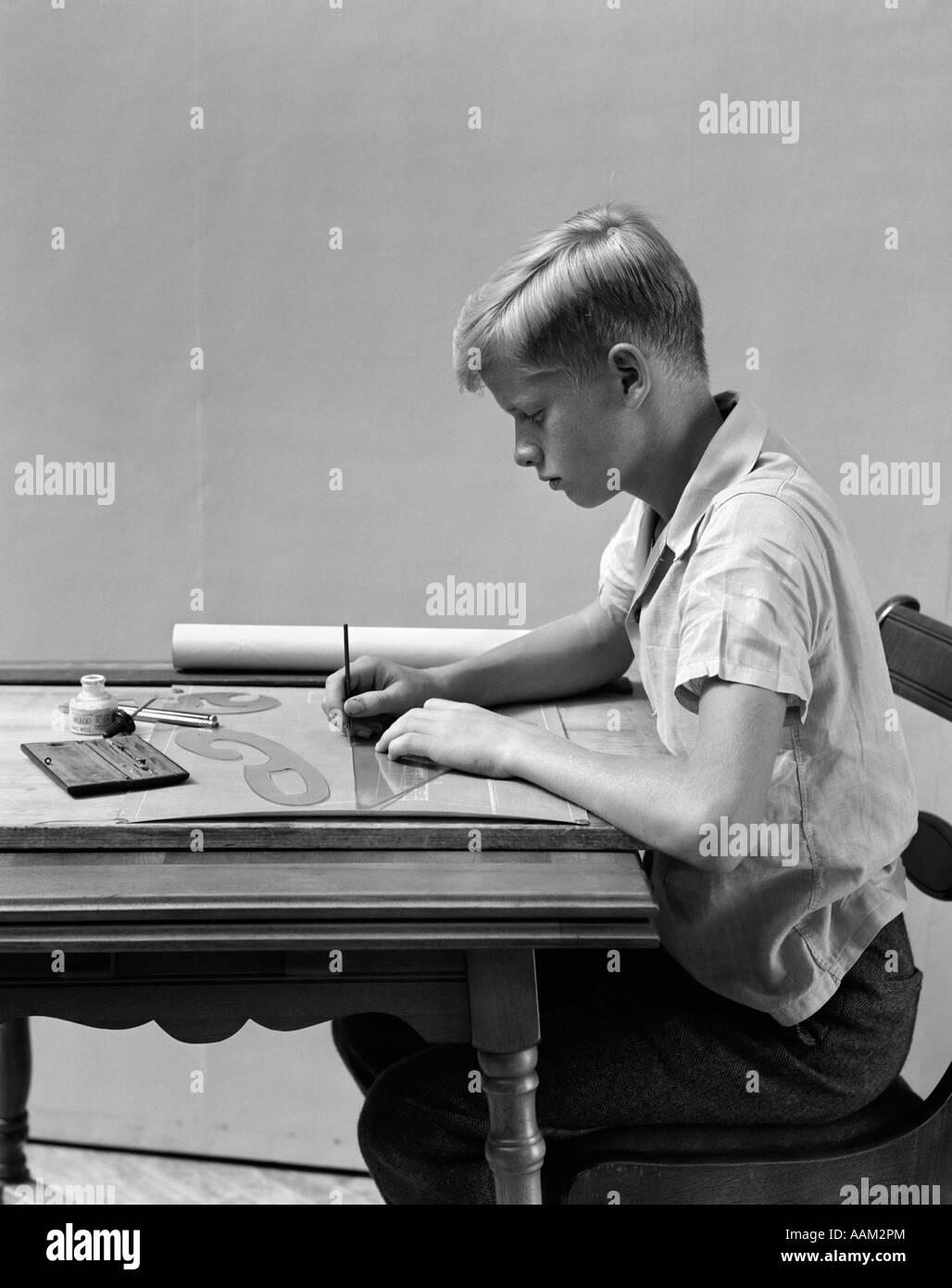 1940s BLOND TEEN BOY AT TABLE USING MECHANICAL DRAWING TOOLS TEMPLATES ...