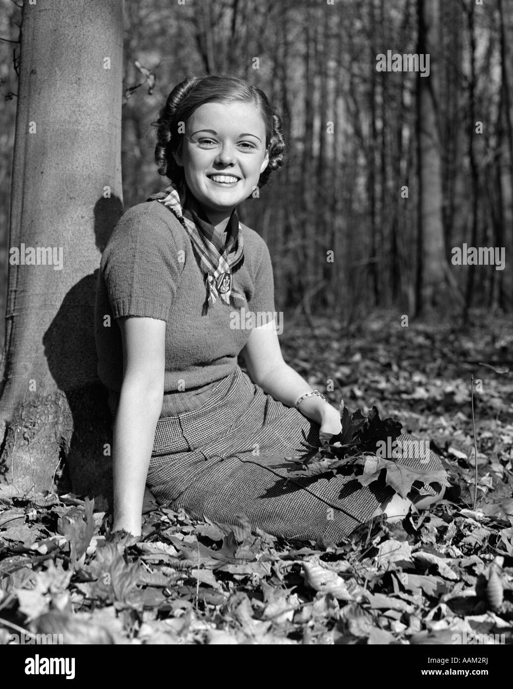1940s PRETTY SMILING TEEN YOUNG WOMAN GIRL SITTING UNDER TREE IN AUTUMN ...