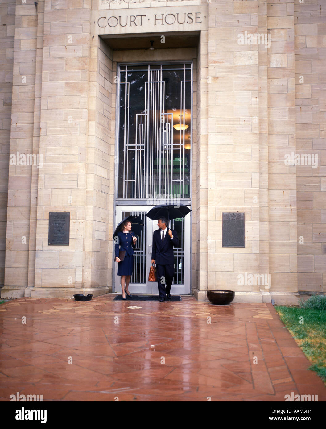 MAN WOMAN COUPLE OUTSIDE OF COURTHOUSE IN THE RAIN ATTORNEY ATTORNEYS ...
