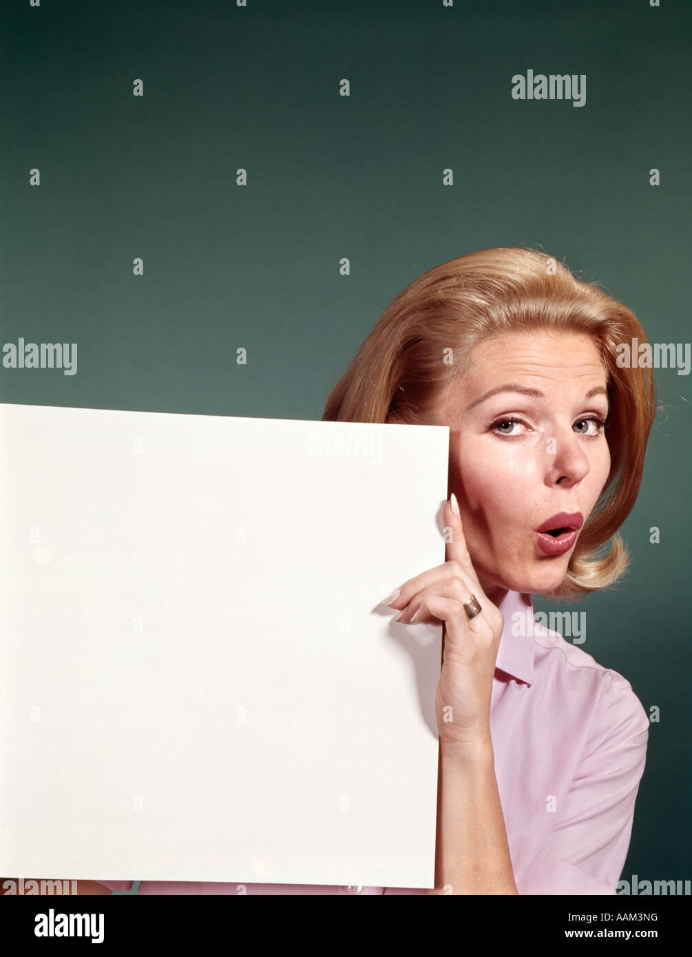 1960s PORTRAIT OF SURPRISED WOMAN PEEKING AROUND SIGN BOARD Stock Photo ...