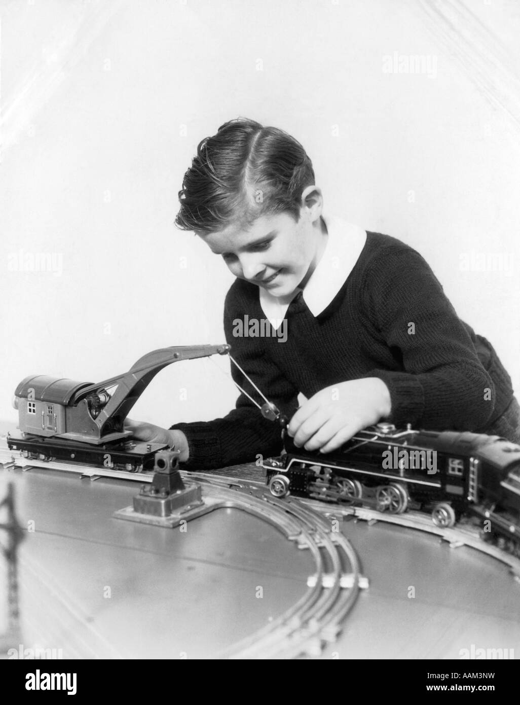 Vintage children playing with train set Black and White Stock Photos ...