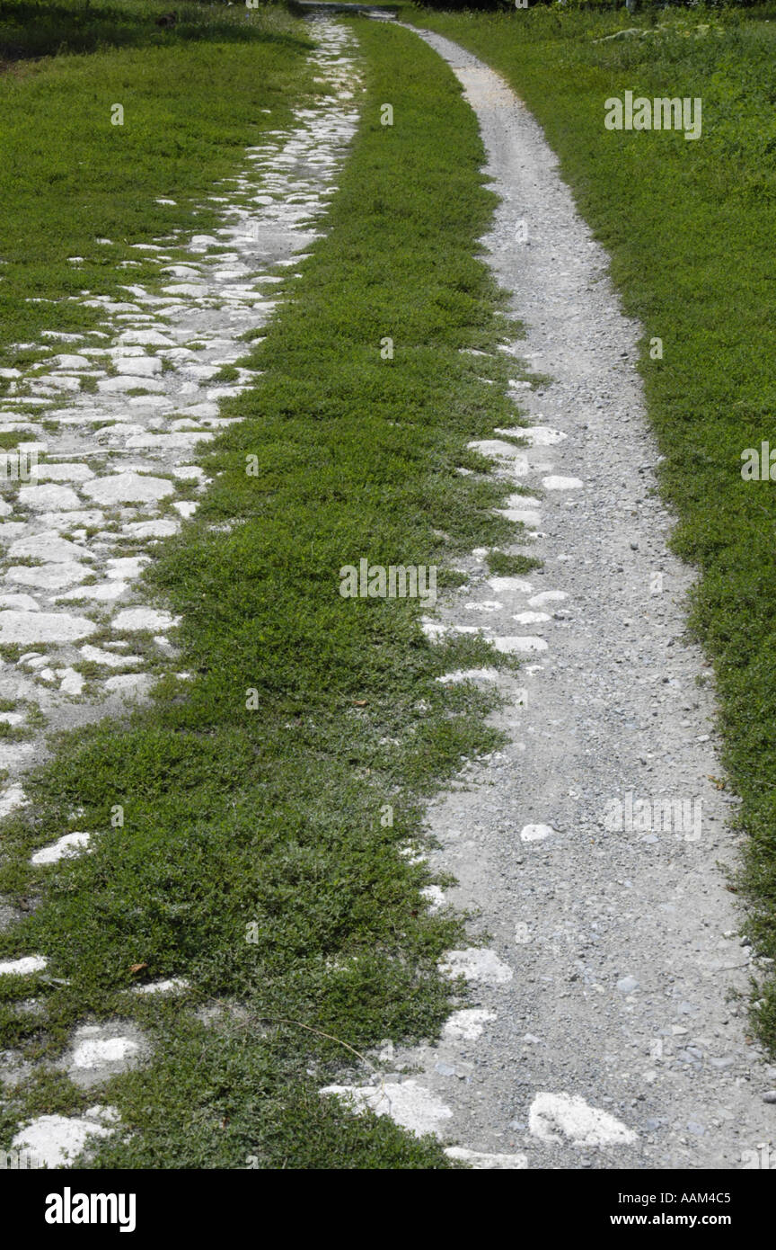 gravel road, green middle line Stock Photo - Alamy