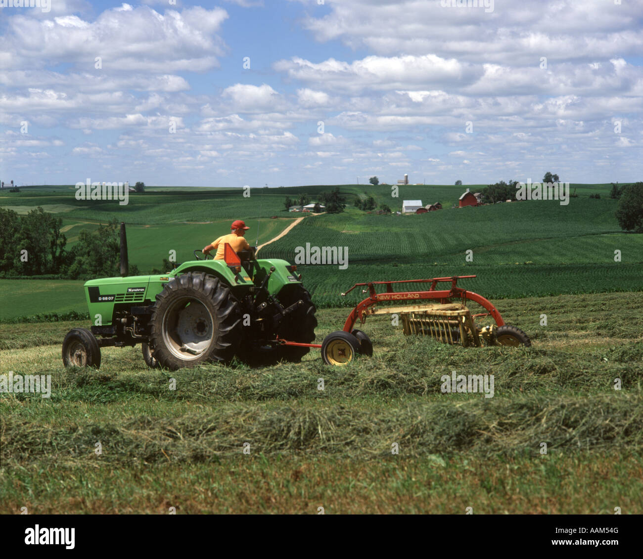 1970s 1980s Man Farmer Driving Green Tractor Pulling A Hay Rake Dubuque