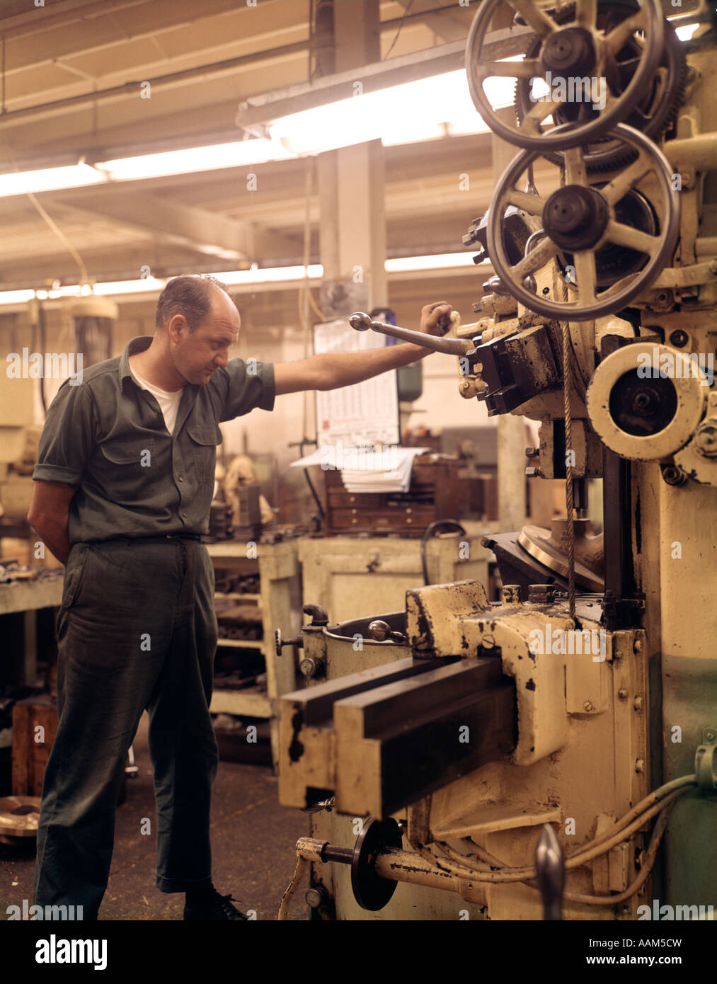 1960s INDUSTRIAL MACHINIST WORKING MAN USING VERTICAL MILLING MACHINE ...