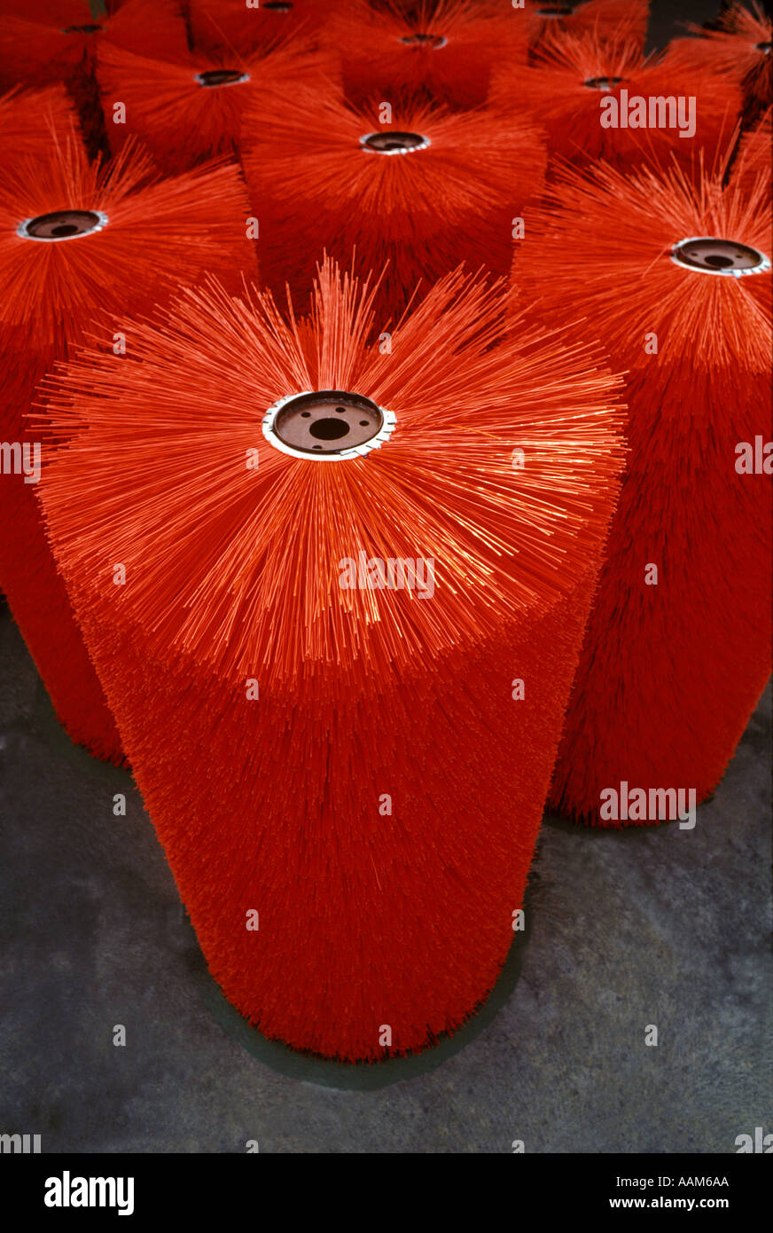 Rows of red street sweeper brushes Stock Photo - Alamy