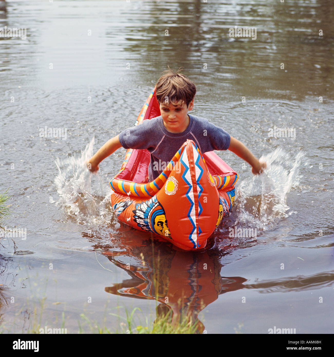 1970s BRUNETTE BOY IN BLUE SHIRT IN RED INFLATABLE CANOE INDIAN MOTIF ...