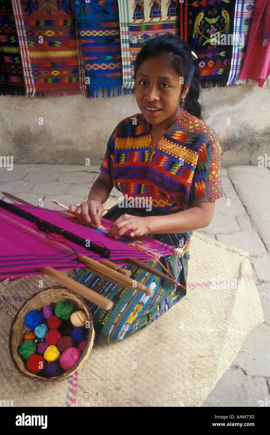 INDIGENOUS WOMAN with traditional BACKSTRAP LOOM weaving a HUIPIL a ...