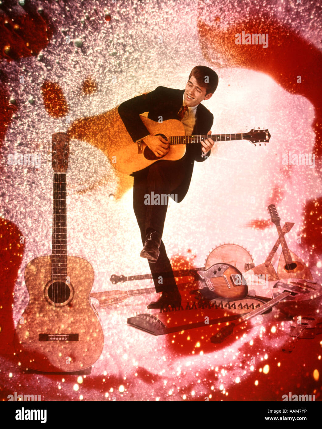 1970 1970s YOUNG MAN MUSICIAN PLAYING GUITAR ROCK MUSIC SURROUNDED BY ...